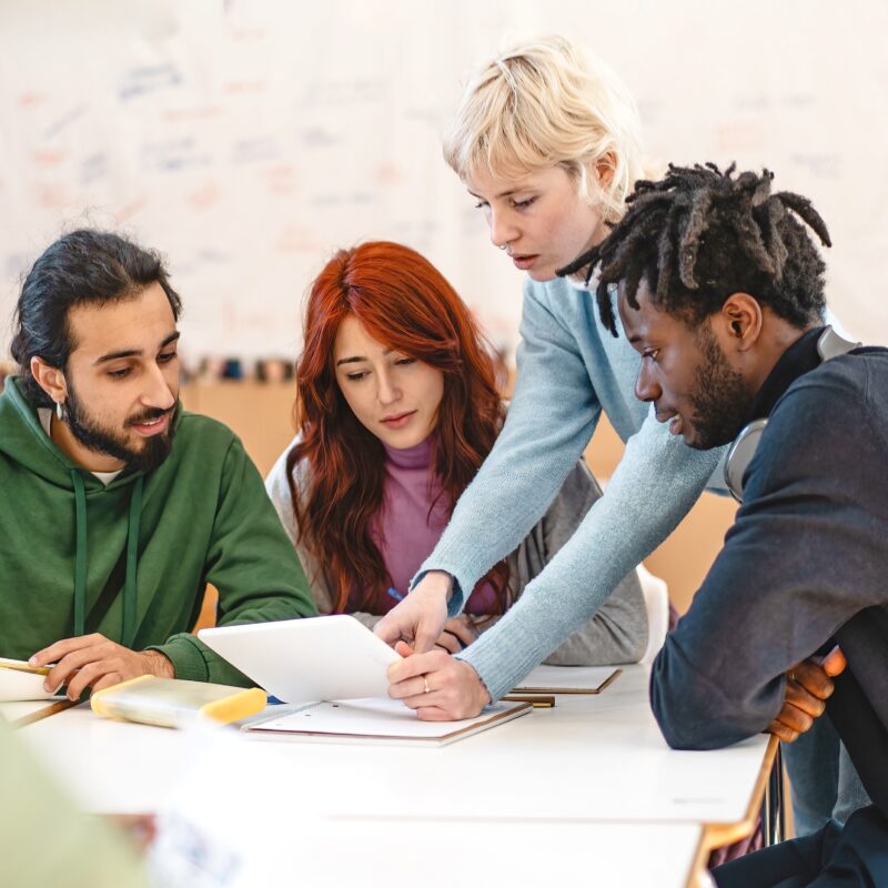 Group of diverse college students working together on a project in a ...